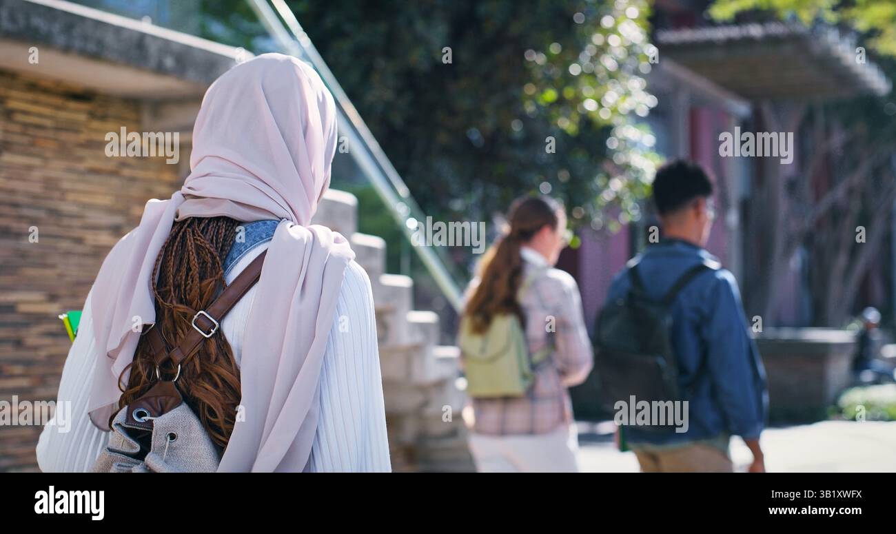 University, students and woman in hijab walking from back with ...