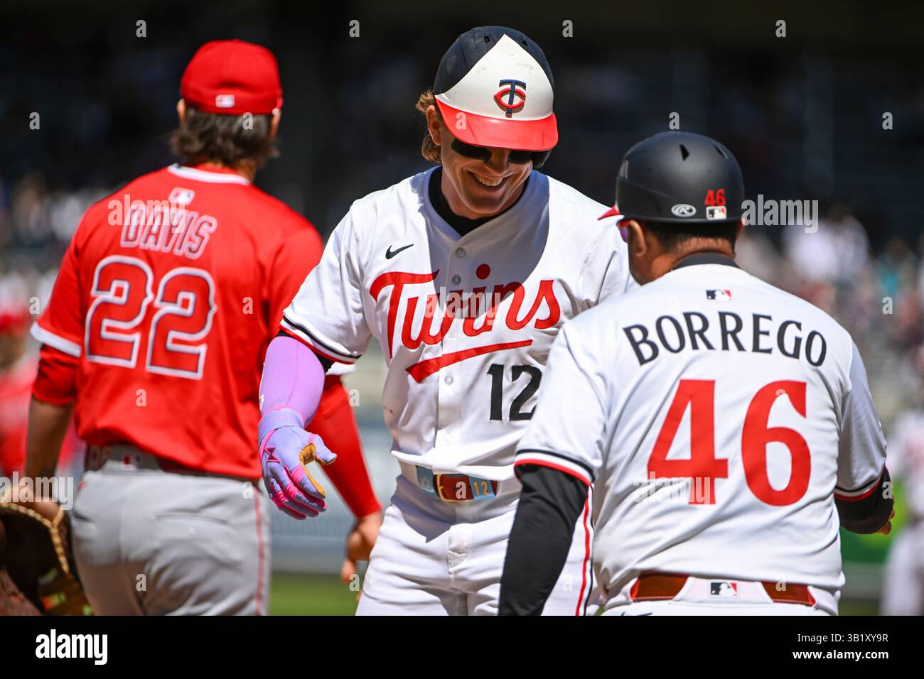 Minnesota Twins' Harrison Bader (12) reacts with first base coach Ramon ...