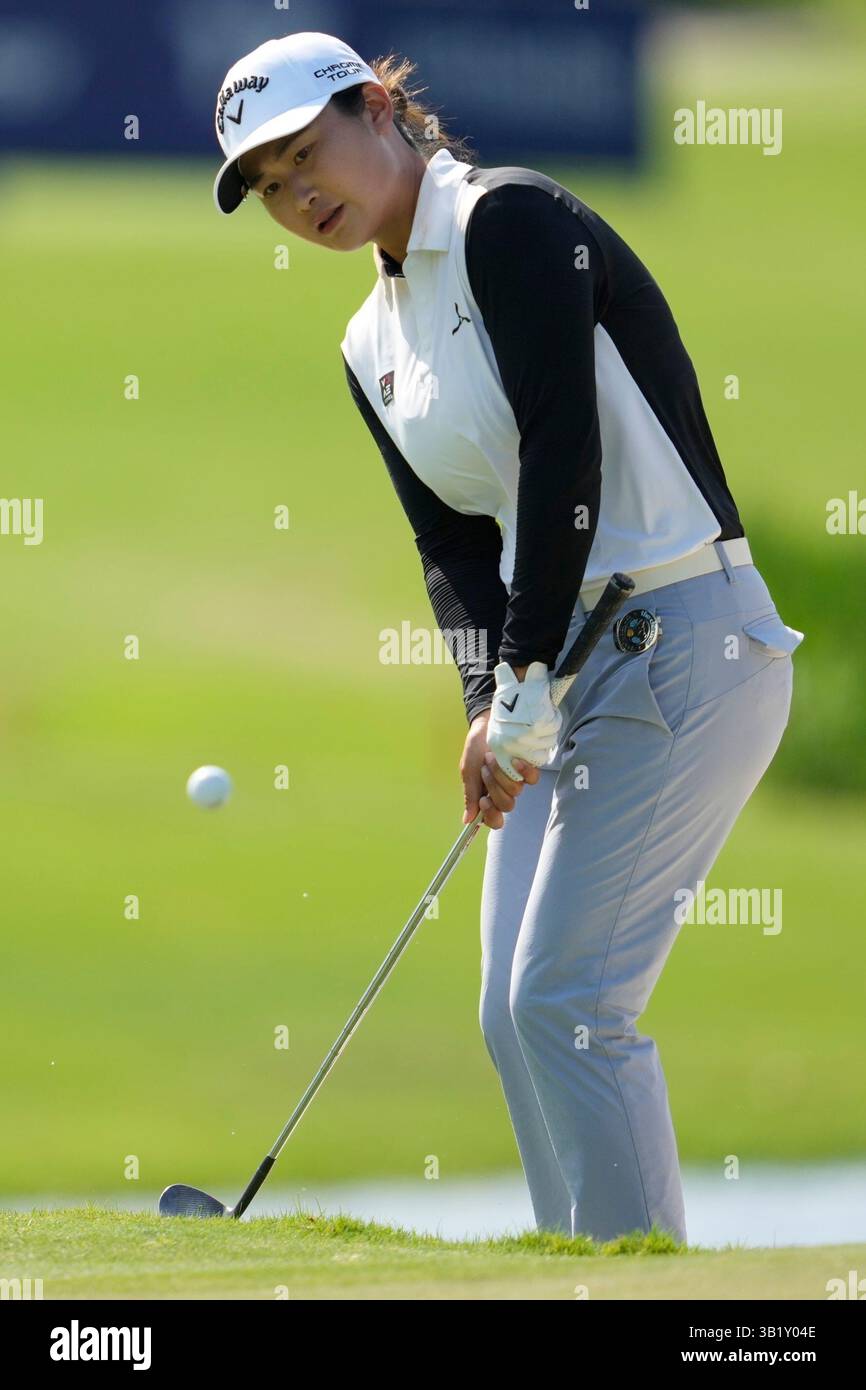 Yan Liu, of China, chips to the 17th green during the third round of ...