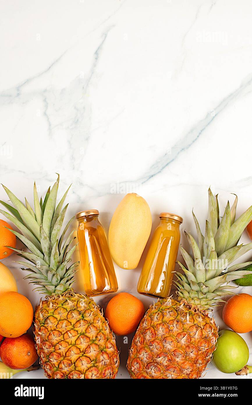 Summer tropical fruits and juices on marble table, source of vitamin C ...