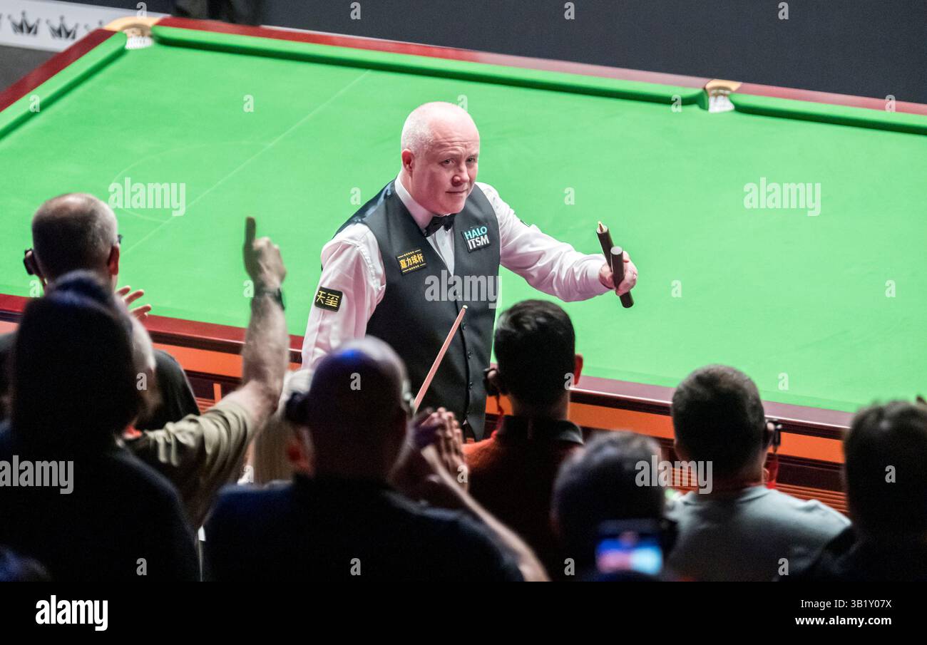 John Higgins celebrates after beating Xiao Guodong, on day eight of the ...