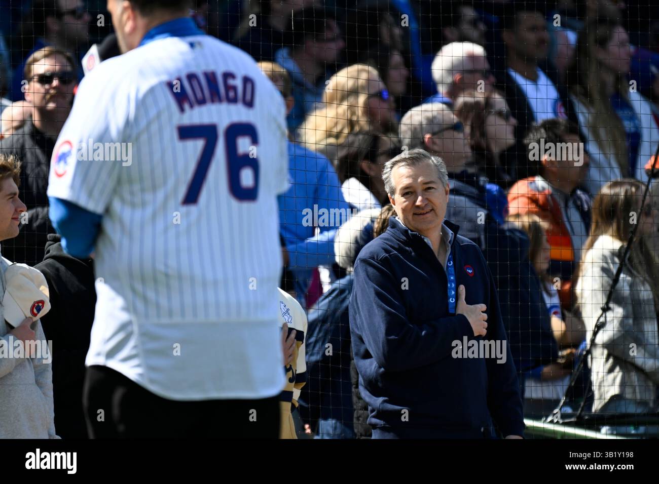 Chicago Cubs chairman Tom Ricketts, right, looks on during the singing ...