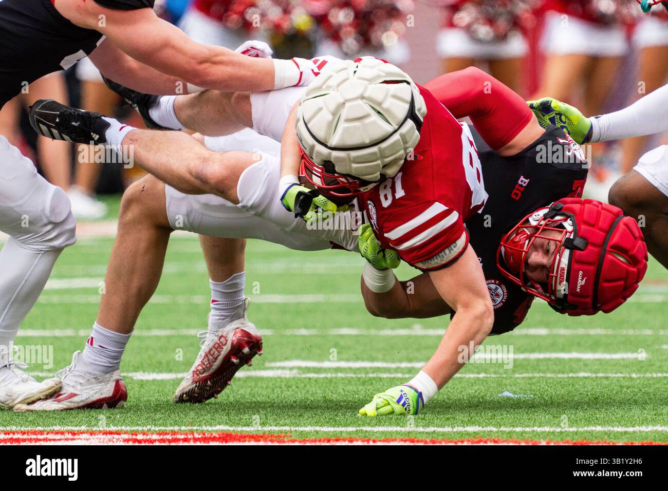 Nebraska linebacker Derek Wacker (42) tackles wide receiver Hayes ...