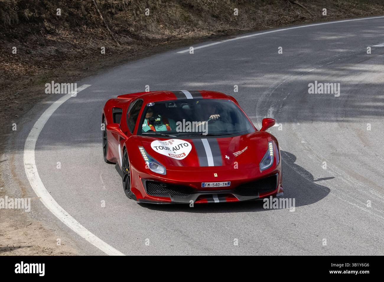Le Valtin, France - View on a burgundy Ferrari 488 Pista driving on a ...