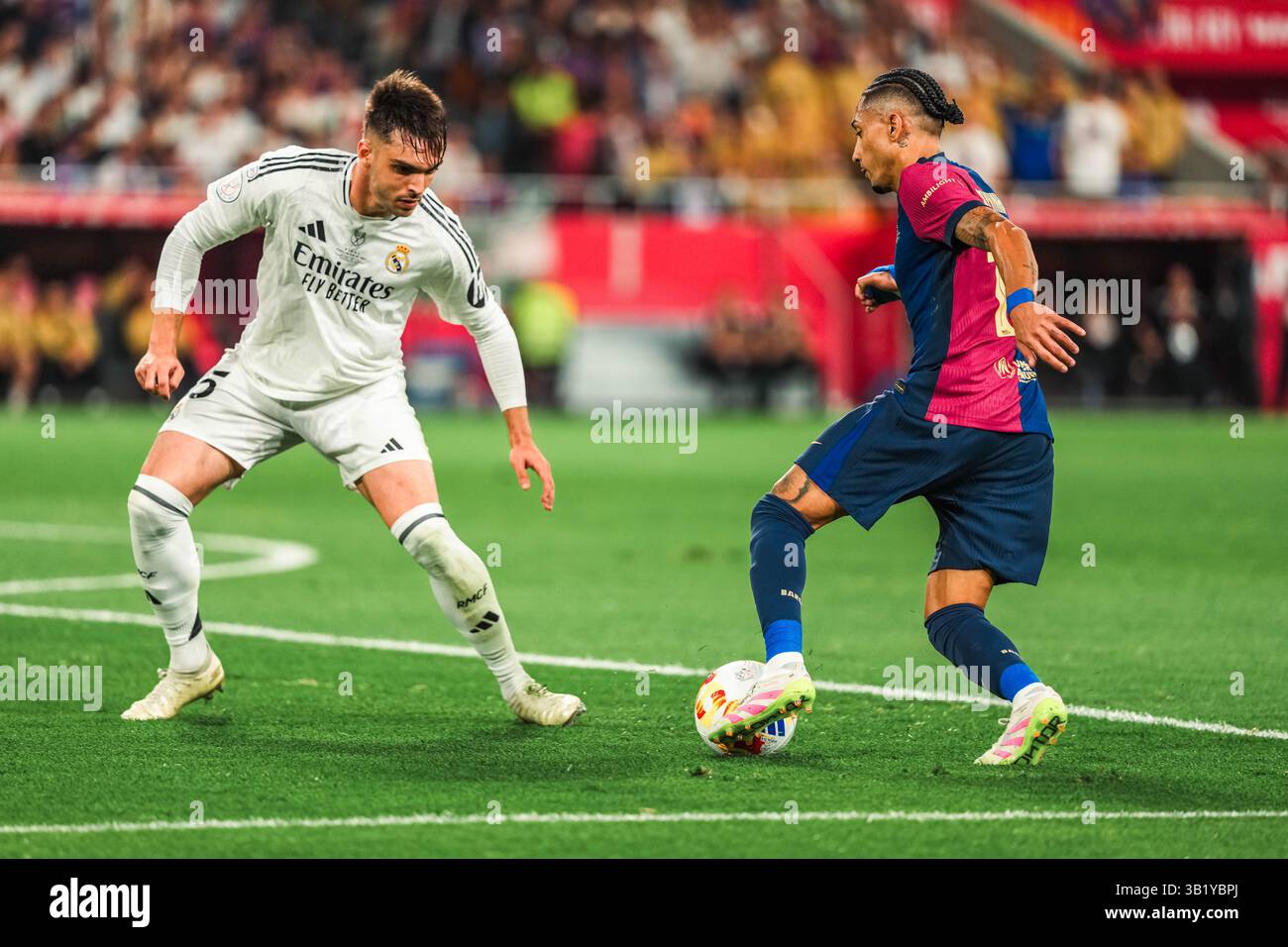 Raul Asencio of Real Madrid CF and Raphinha of FC Barcelona during the ...