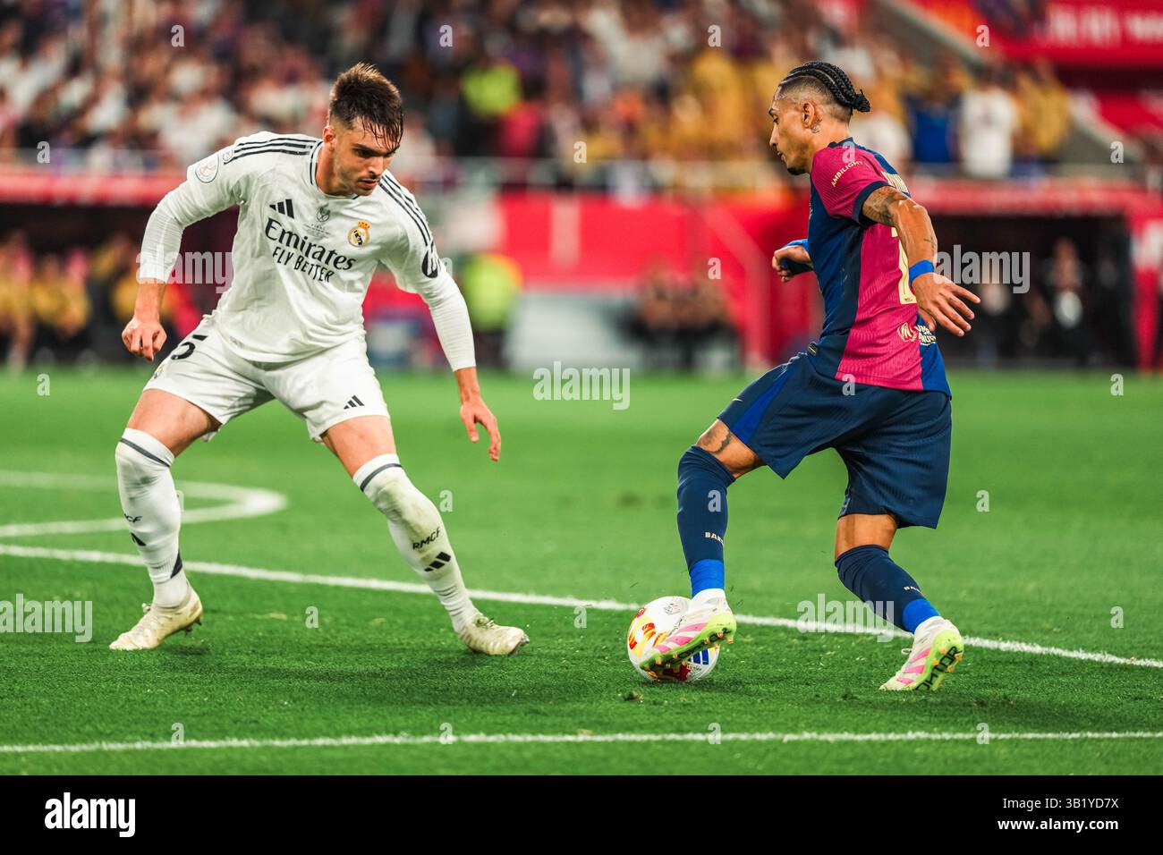 Raul Asencio of Real Madrid CF and Raphinha of FC Barcelona during the ...