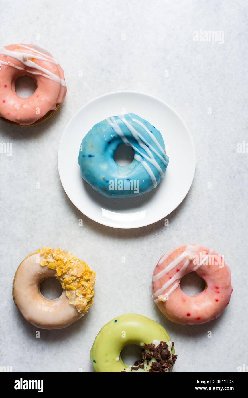 Overhead view of glazed donuts on a white countertop, top view of ...