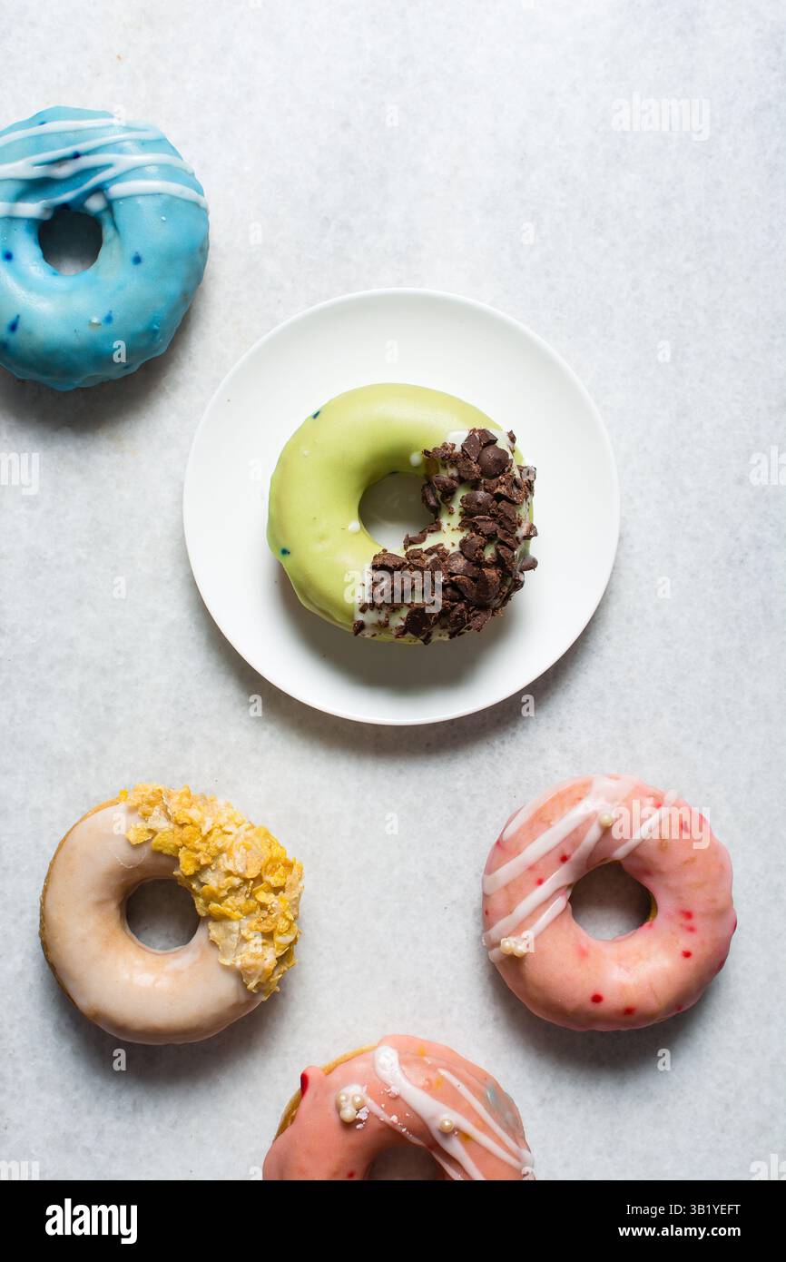 Overhead view of glazed donuts on a white countertop, top view of ...