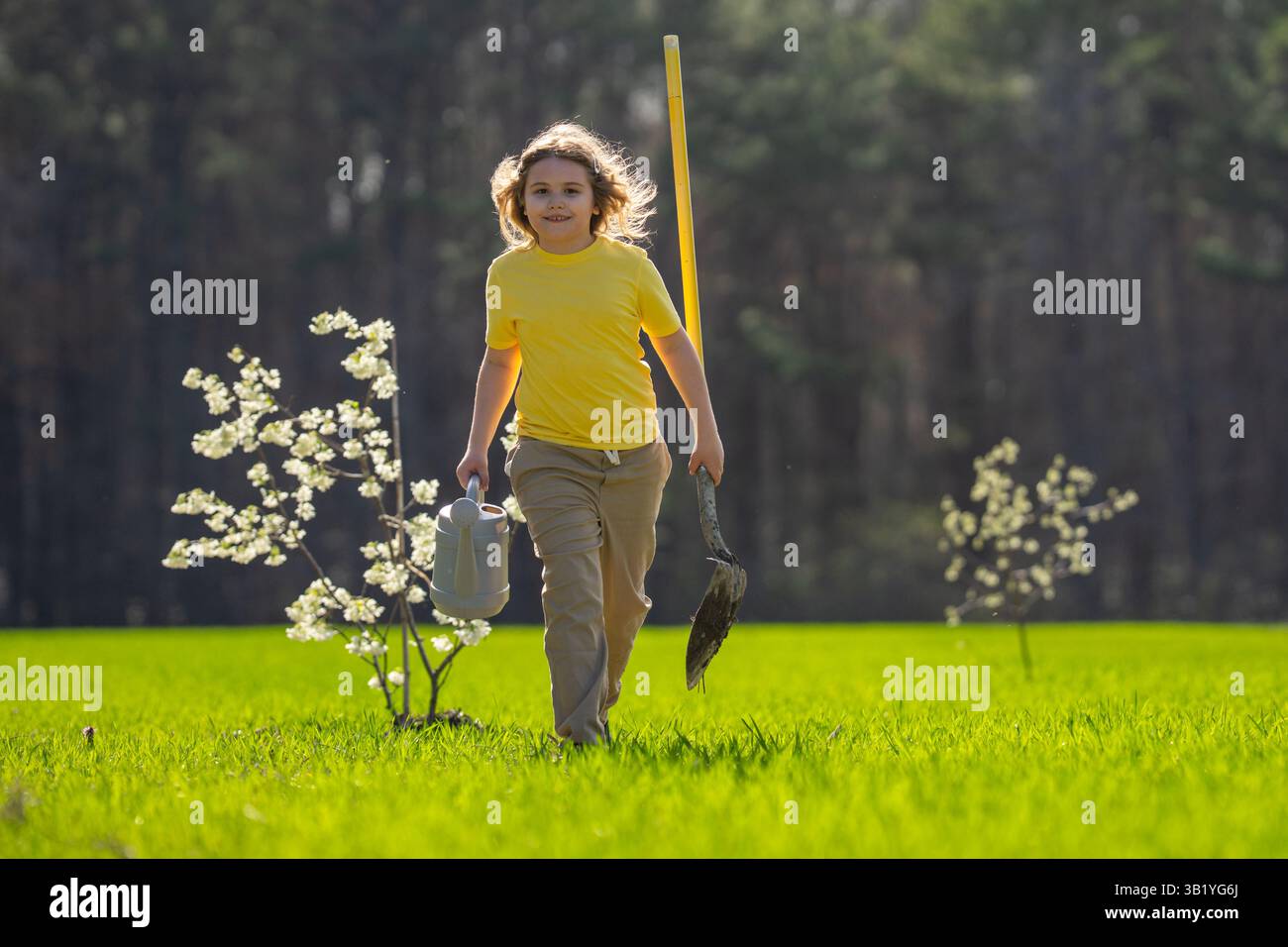 Kid growing a tree in garden. Kid digging soil with shovel and planting ...