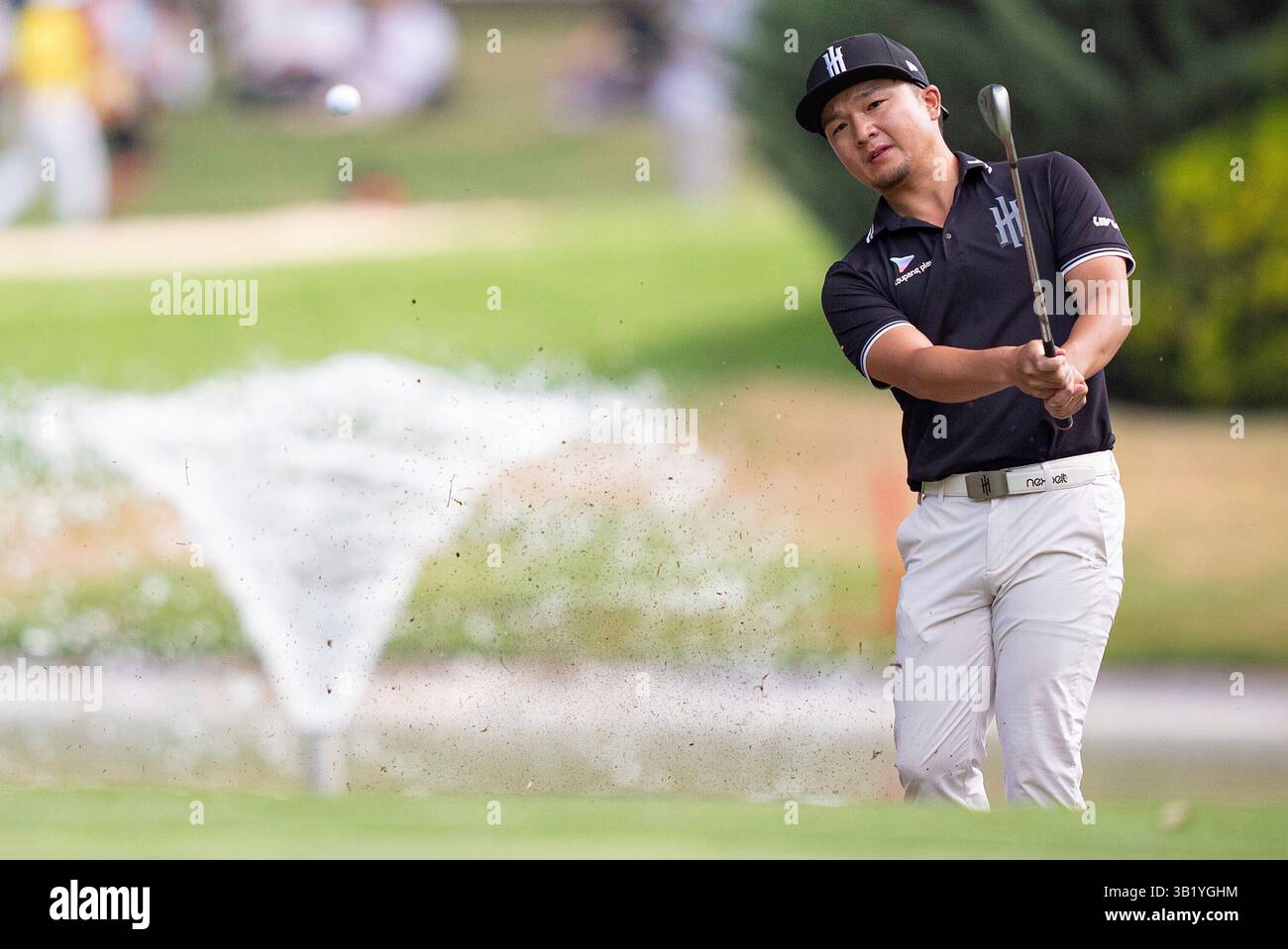 Jinichiro Kozuma of Iron Heads GC hits his shot on the eighth hole ...