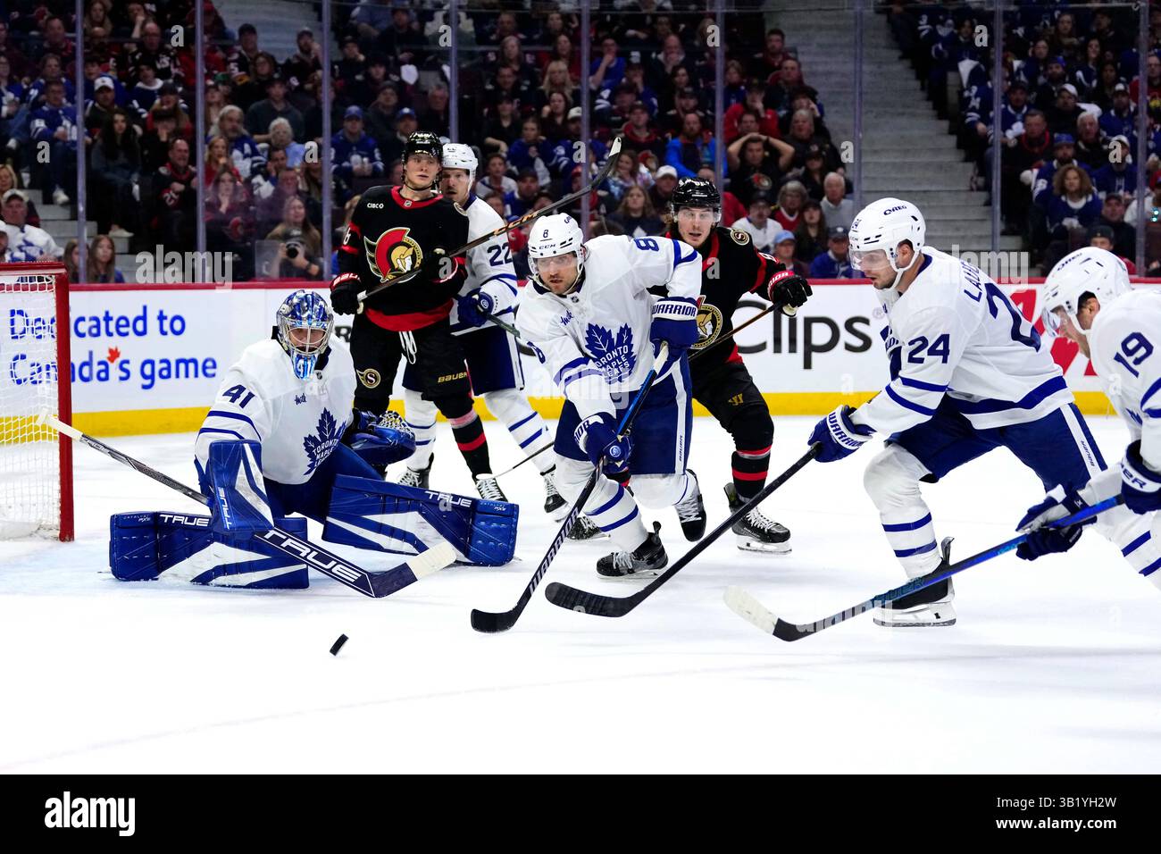 Toronto Maple Leafs' Chris Tanev (8), Scott Laughton (24) and Calle ...