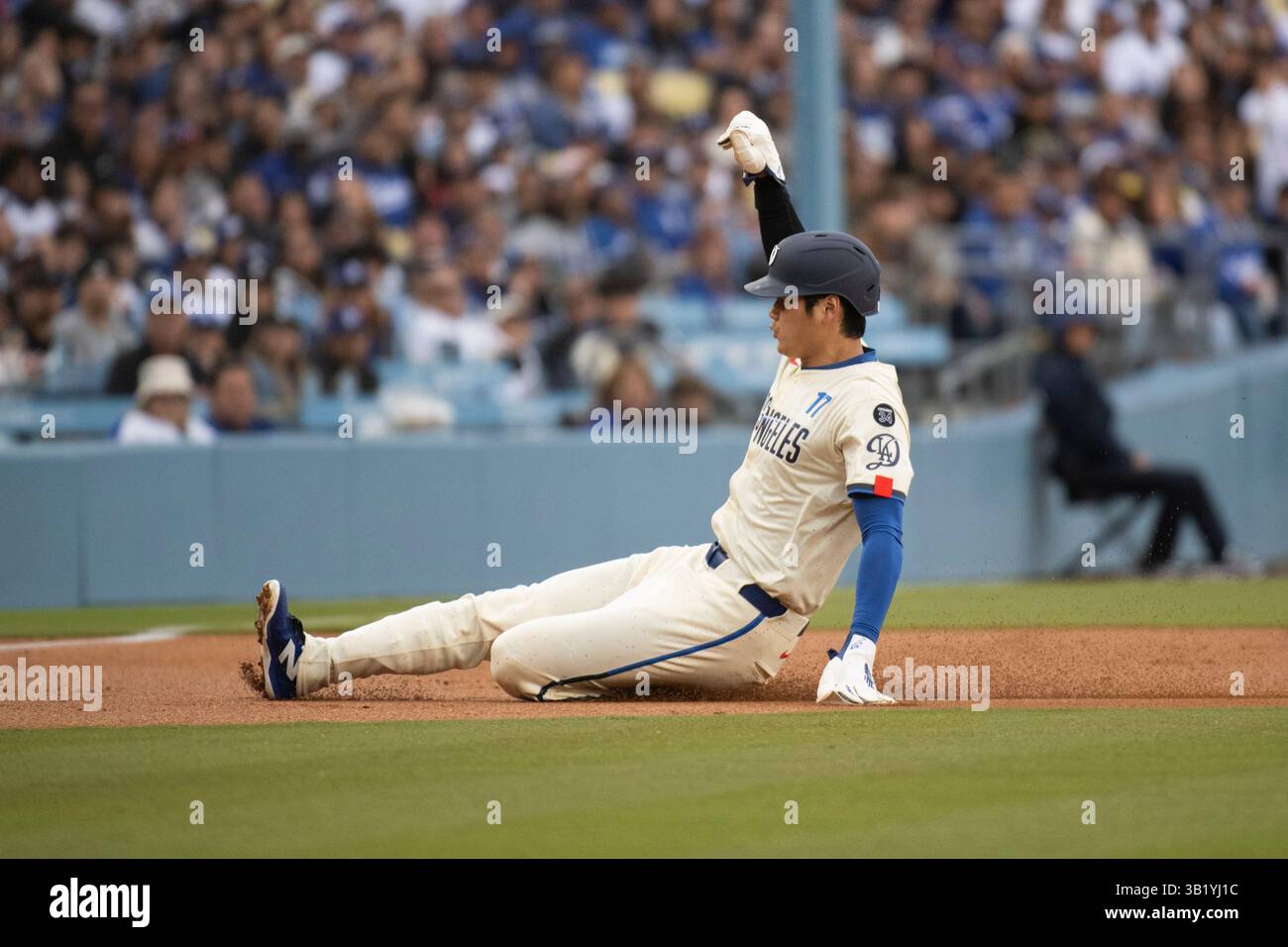 Los Angeles Dodgers' Shohei Ohtani slides into third base during the ...