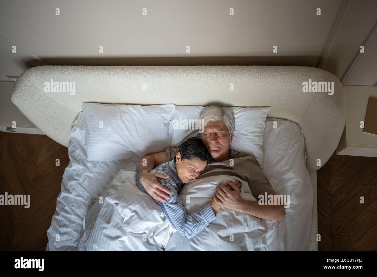 Love and understanding in long term relationship, couple sleeping hugging in bed, peaceful ...