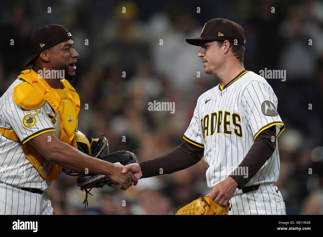San Diego Padres relief pitcher Ryan Bergert is greeted by catcher ...