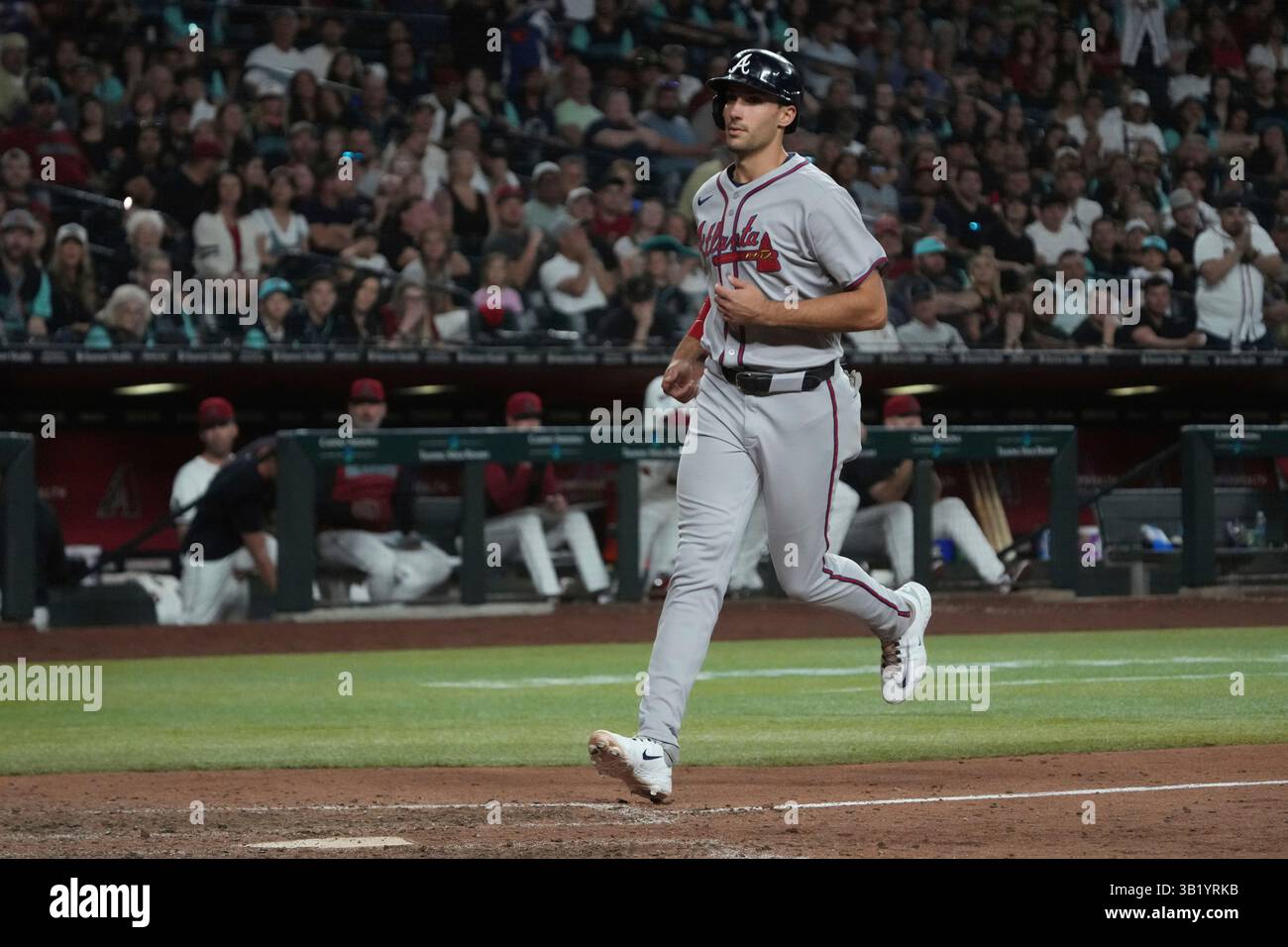 Atlanta Braves' Matt Olson scores on a wild pitch by Arizona Diamondbacks' Justin Martinez in ...