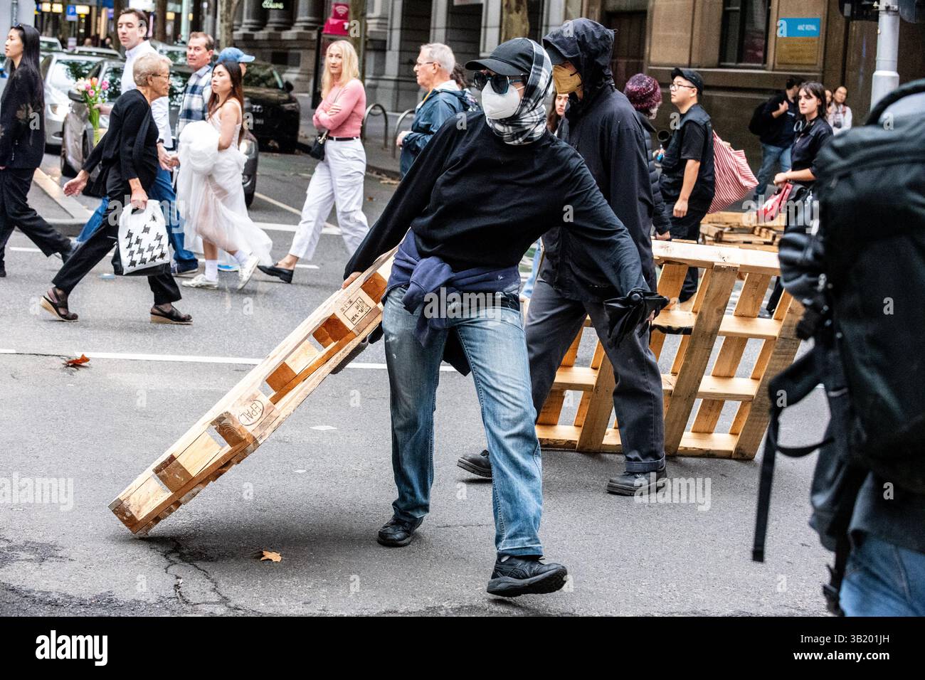 Pro-trans protesters position wooden pallets to block the road as ...
