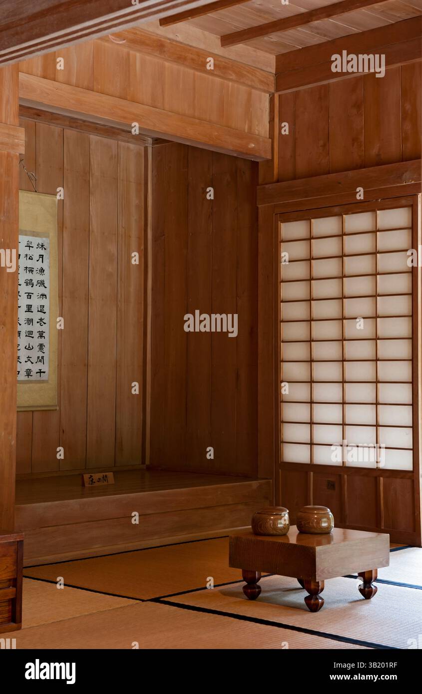 Hanging scroll in tokonoma alcove, go game board and shoji screen with wood interior of an ...