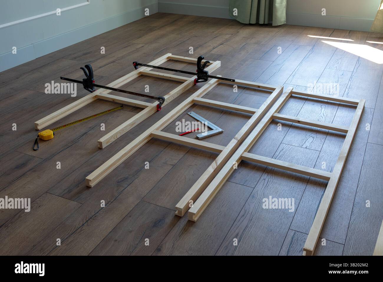 process of making a wooden rack, parts clamped with clamps, carpentry ...
