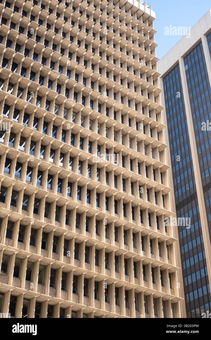 A detailed view of a building facade featuring a repetitive pattern of ...
