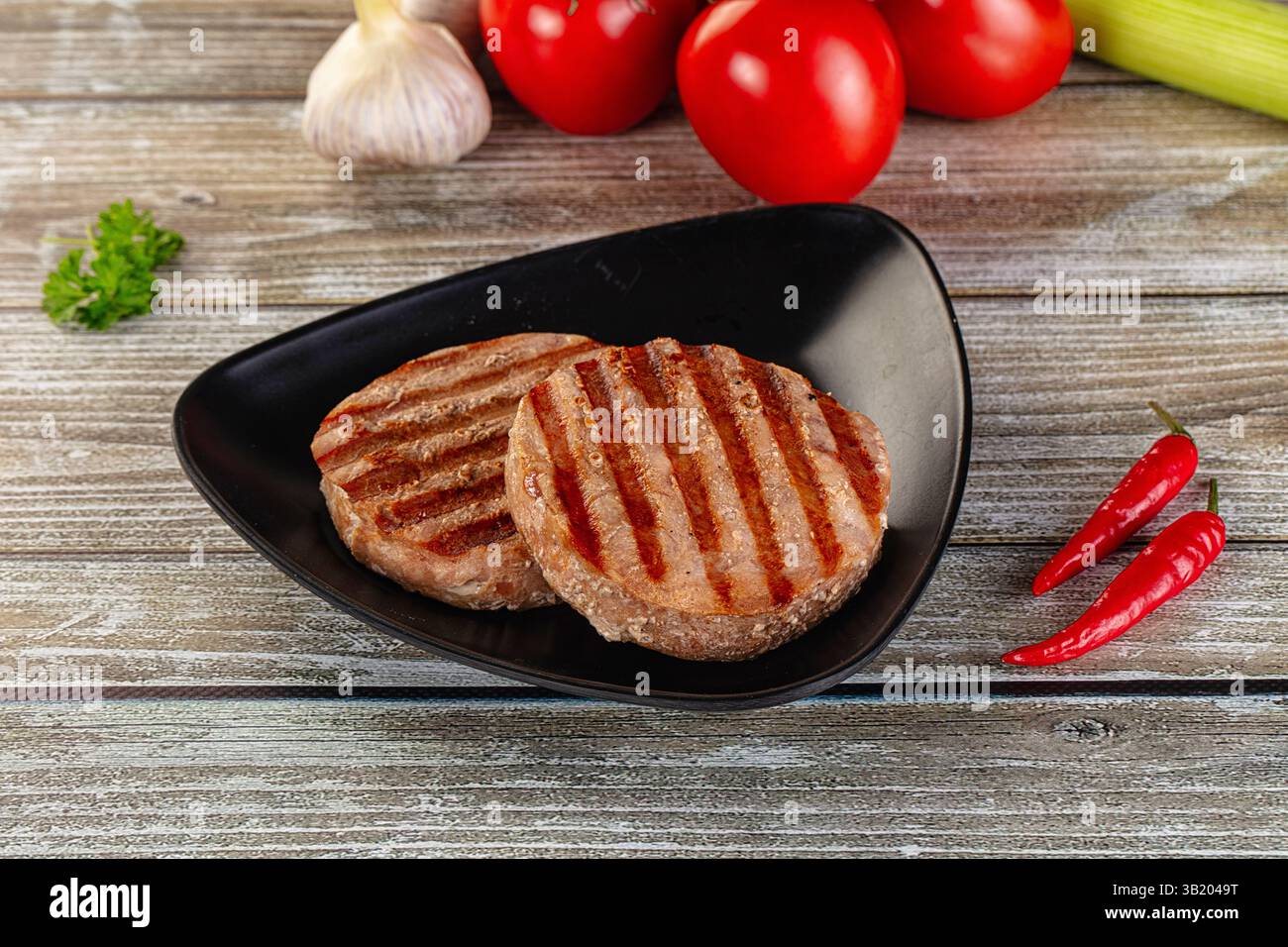 Grilled tuna steak fillet round medallion Stock Photo - Alamy