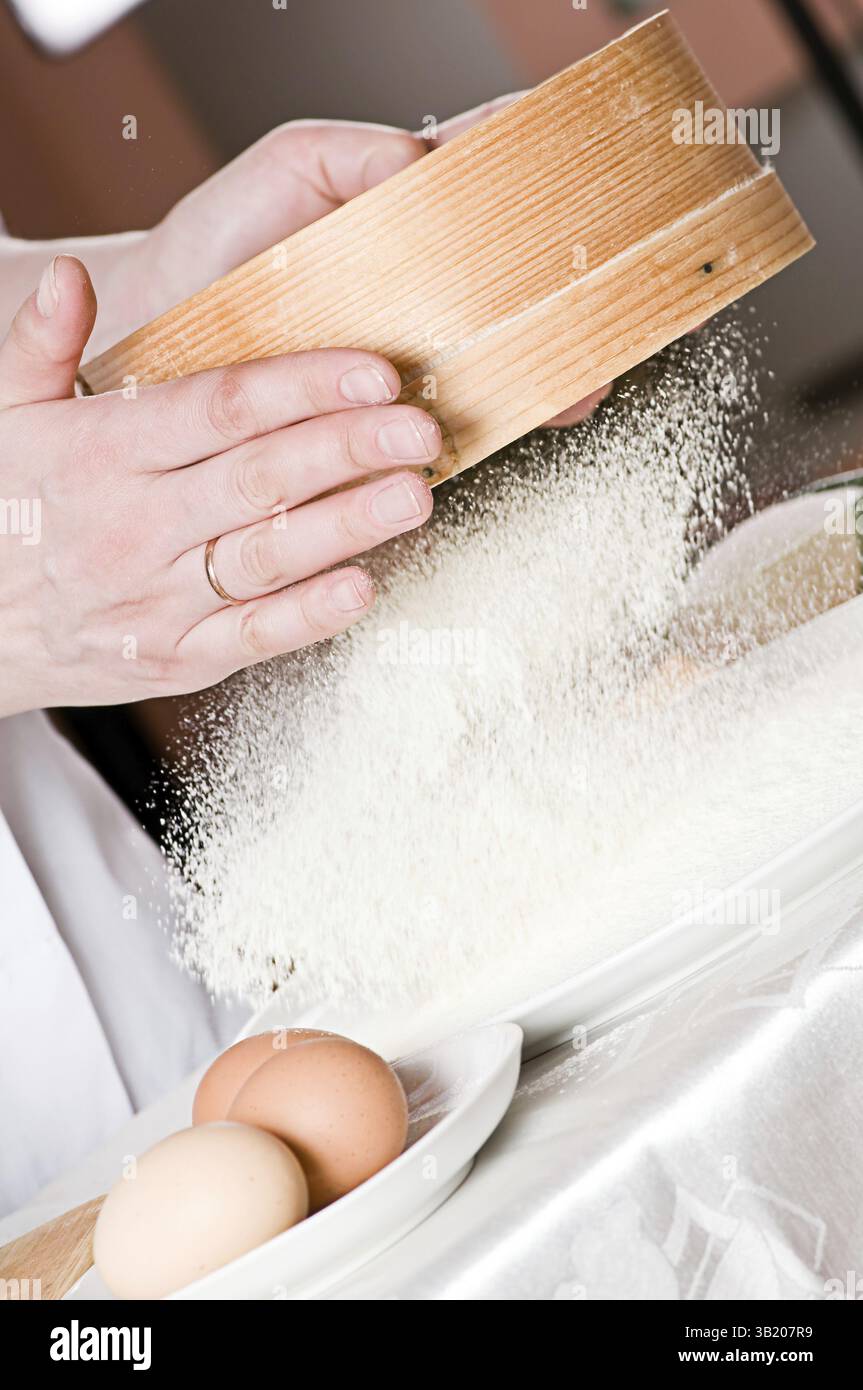 Baker sifts flour through sieve hi-res stock photography and images - Alamy
