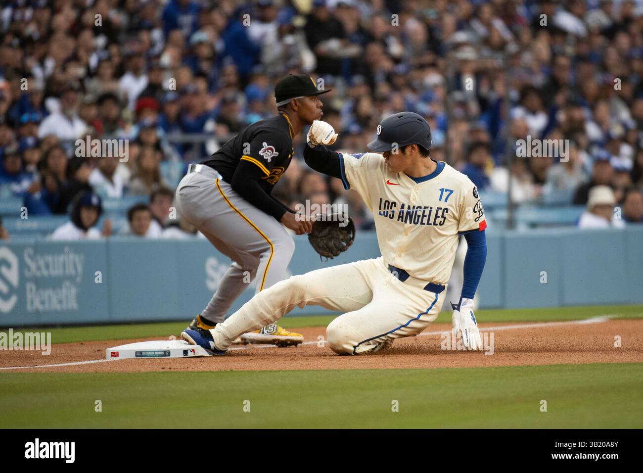 Los Angeles Dodgers' Shohei Ohtani slides into third base during a ...