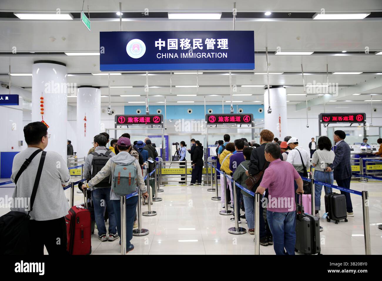 LAINYUNGANG, CHINA - APRIL 27, 2025 - Passengers are queuing up in an ...