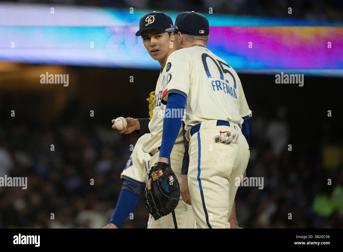 Los Angeles Dodgers first baseman Freddie Freeman, right, dabs starting ...