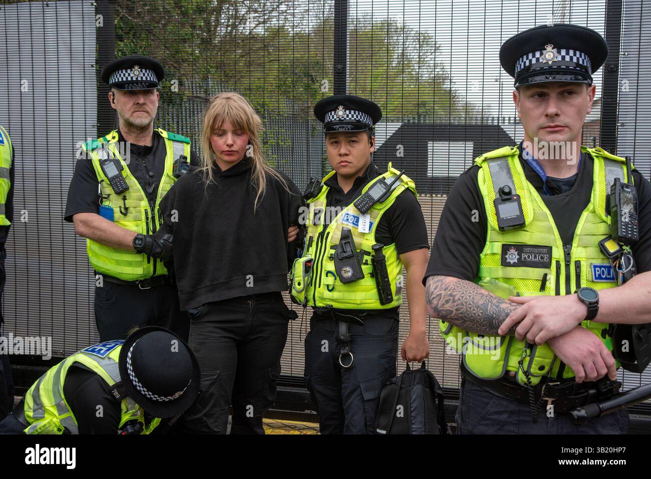 A female protester stands with the police after she was arrested during ...