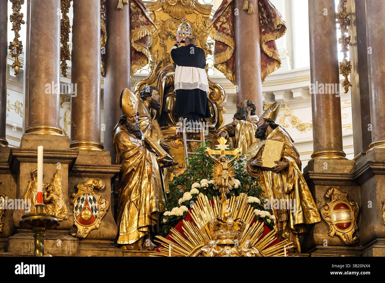 27 April 2025, Bavaria, Munich: Pastor Daniel Lerch (above, M) removes ...