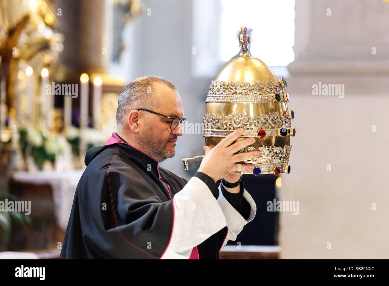 27 April 2025, Bavaria, Munich: Pastor Daniel Lerch wears a papal crown ...