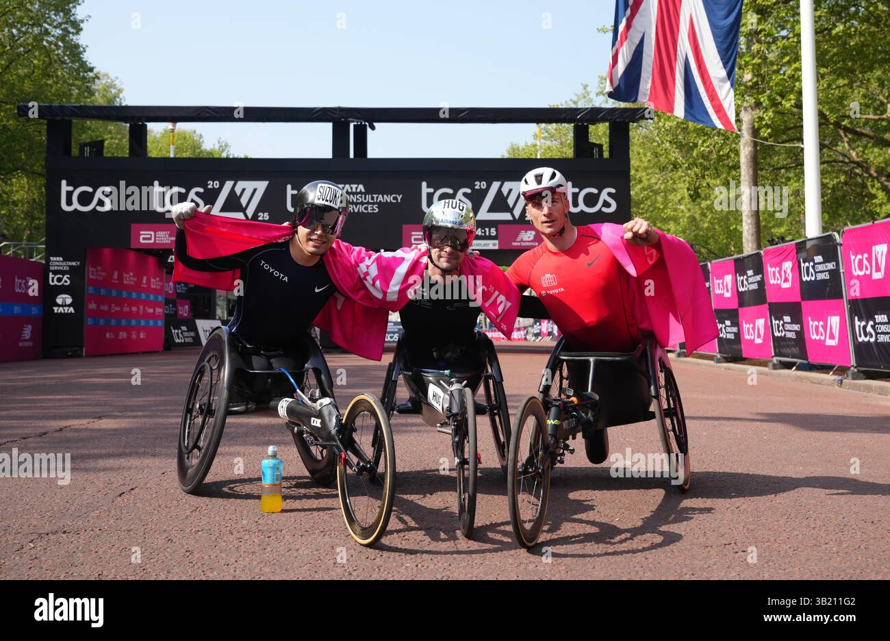 Marcel Hug (centre) celebrates winning the men's wheelchair race ...