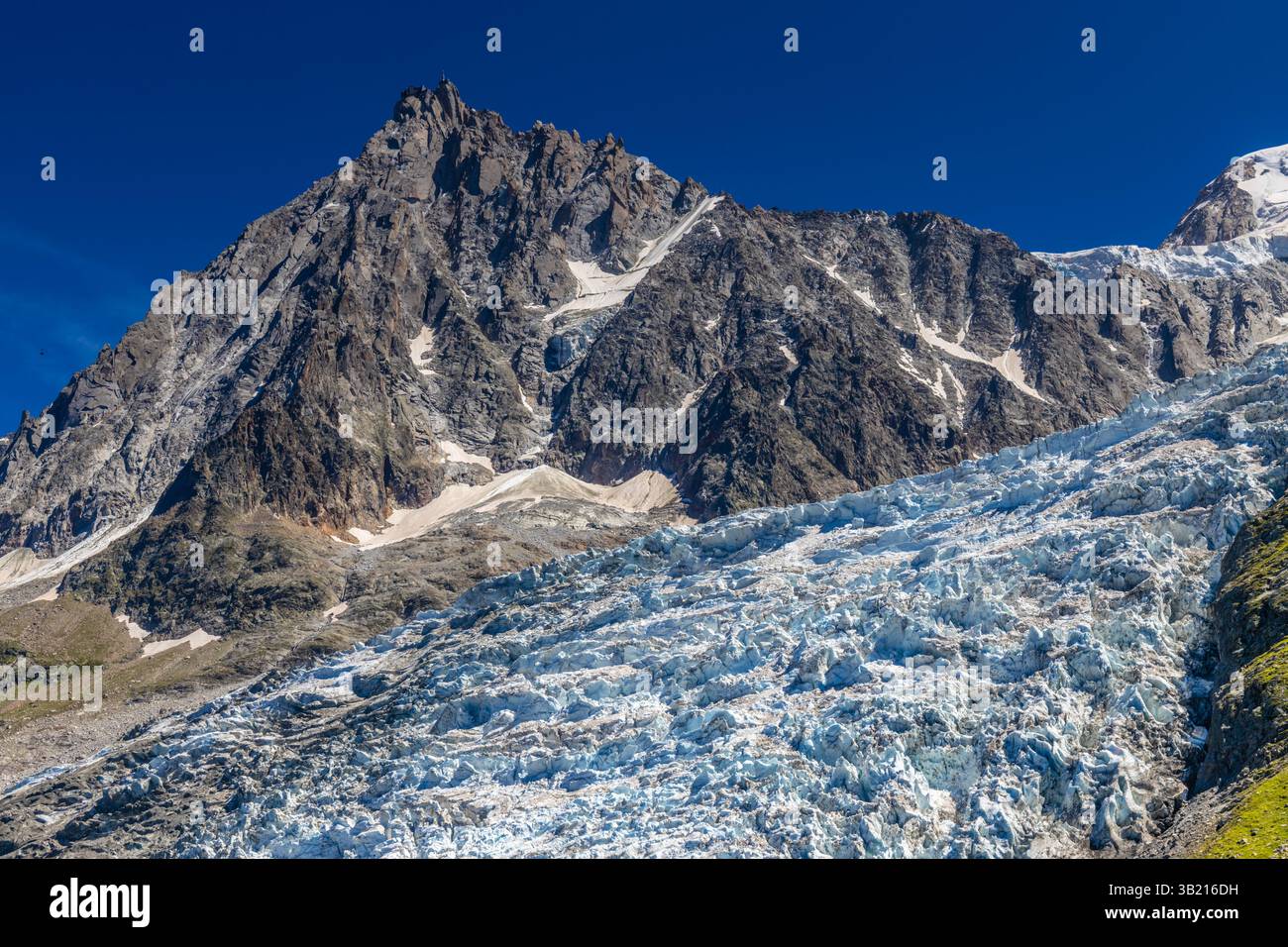 Aiguille du Midi peak in the Alps. Chamonix valley landscape of a prominent rocky towering ...