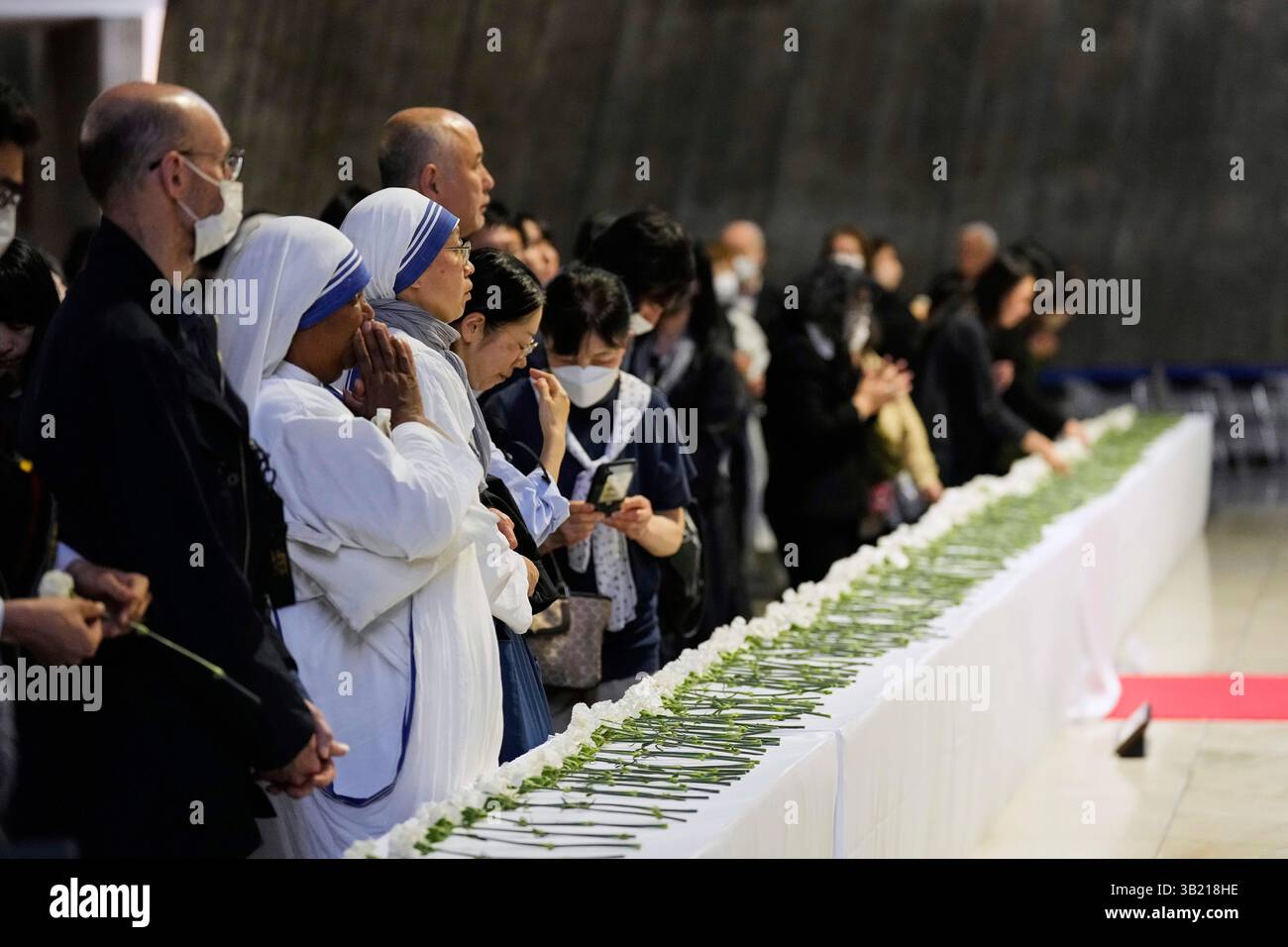 Visitors pray and look at a portrait of the late Pope Francis after ...