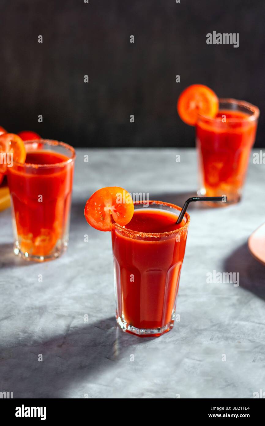Three vegetable shaken cocktail in glass on dark grey background. Red ...