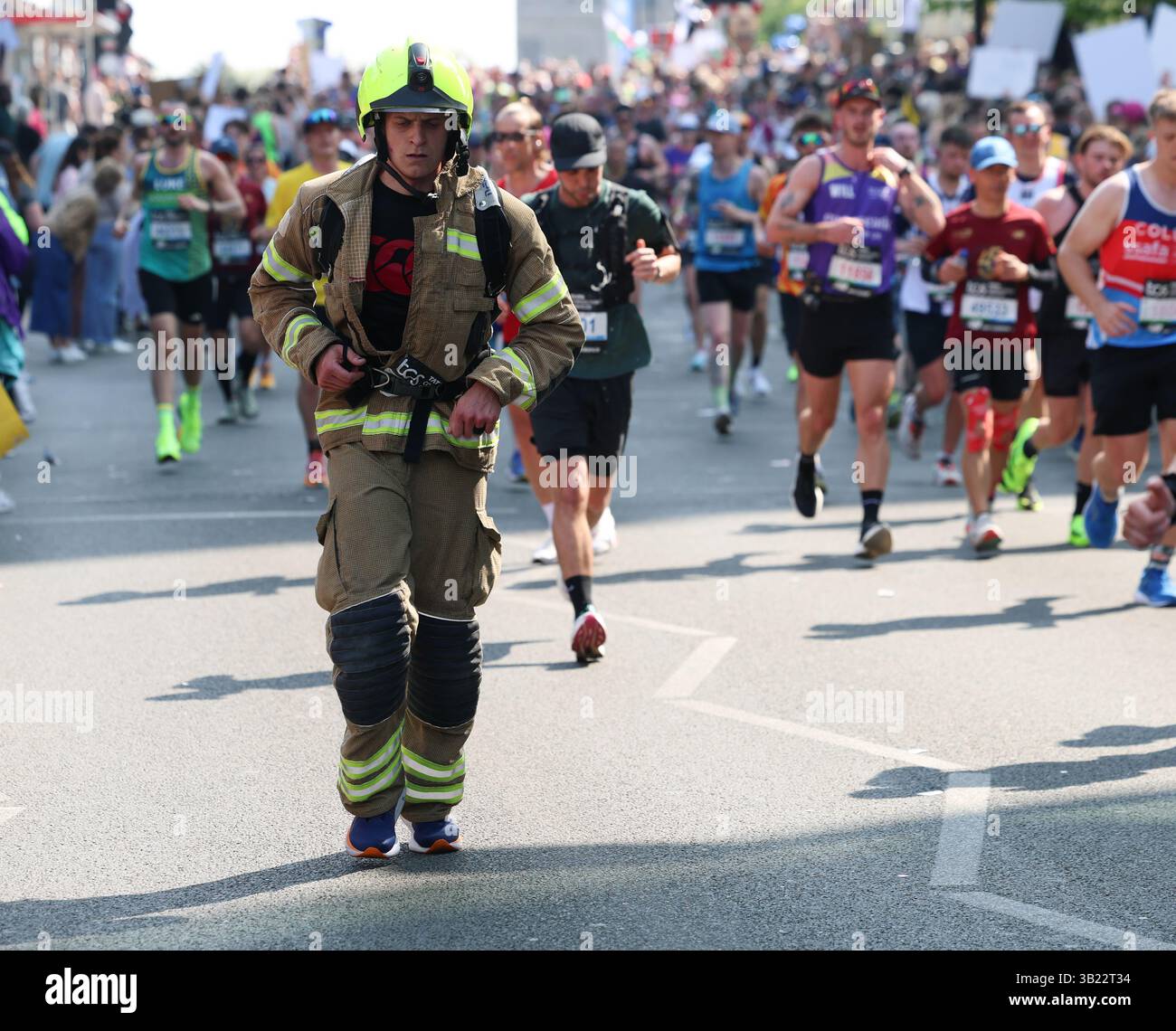 A runner dressed top as a fireman in the TCS London Marathon 2025 ...