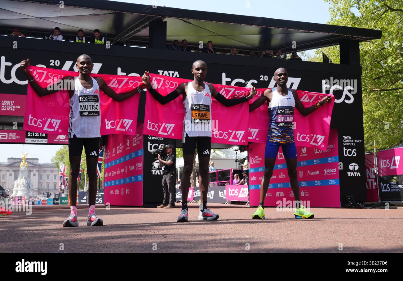 Sabastian Sawe (centre) after winning the men's elite race, alongside ...