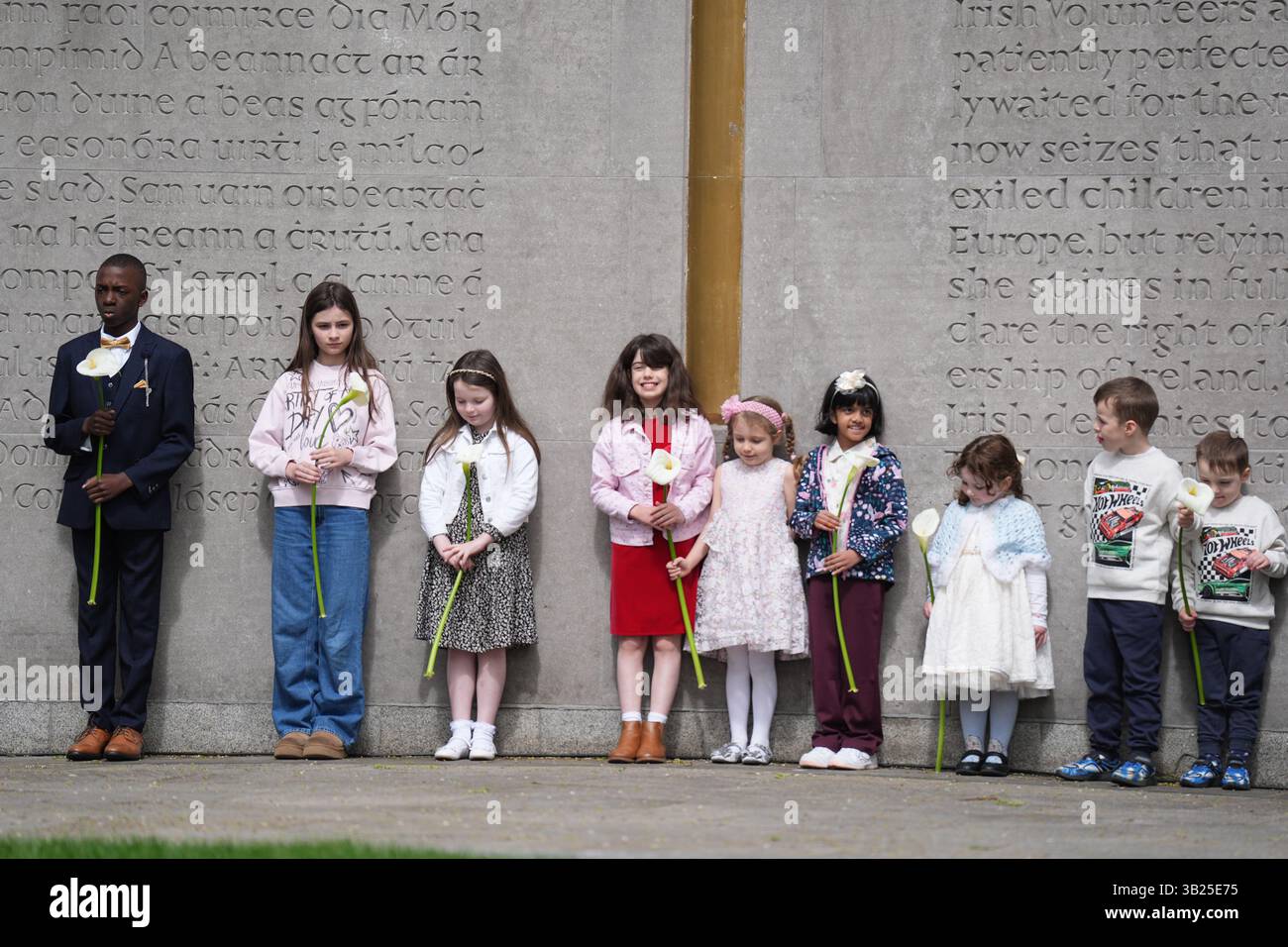 Children hold Easter lilies during Fianna Fail's annual 1916 Easter ...