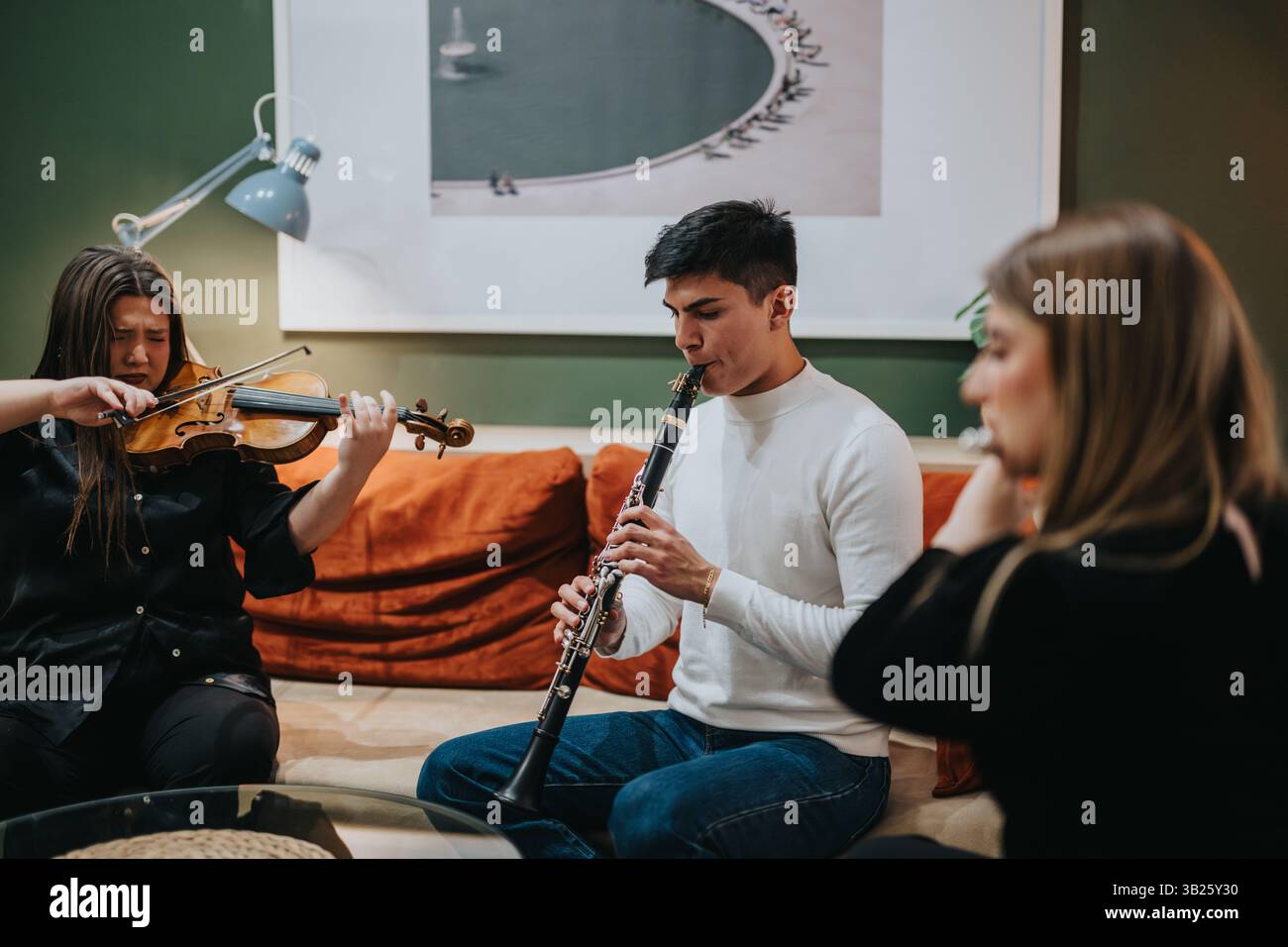 Young musicians practicing together in a cozy indoor setting Stock ...