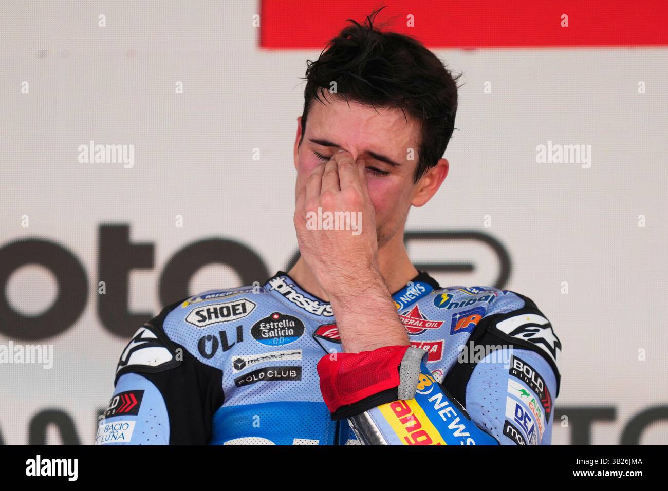 Race winner Spain's rider Alex Marquez of the BK8 Gresini Racing MotoGP reacts on the podium ...