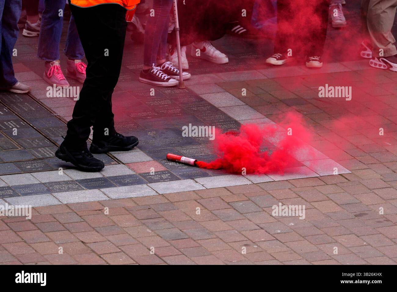 Staff attempt to extinguish a flare that has been set off outside the ...