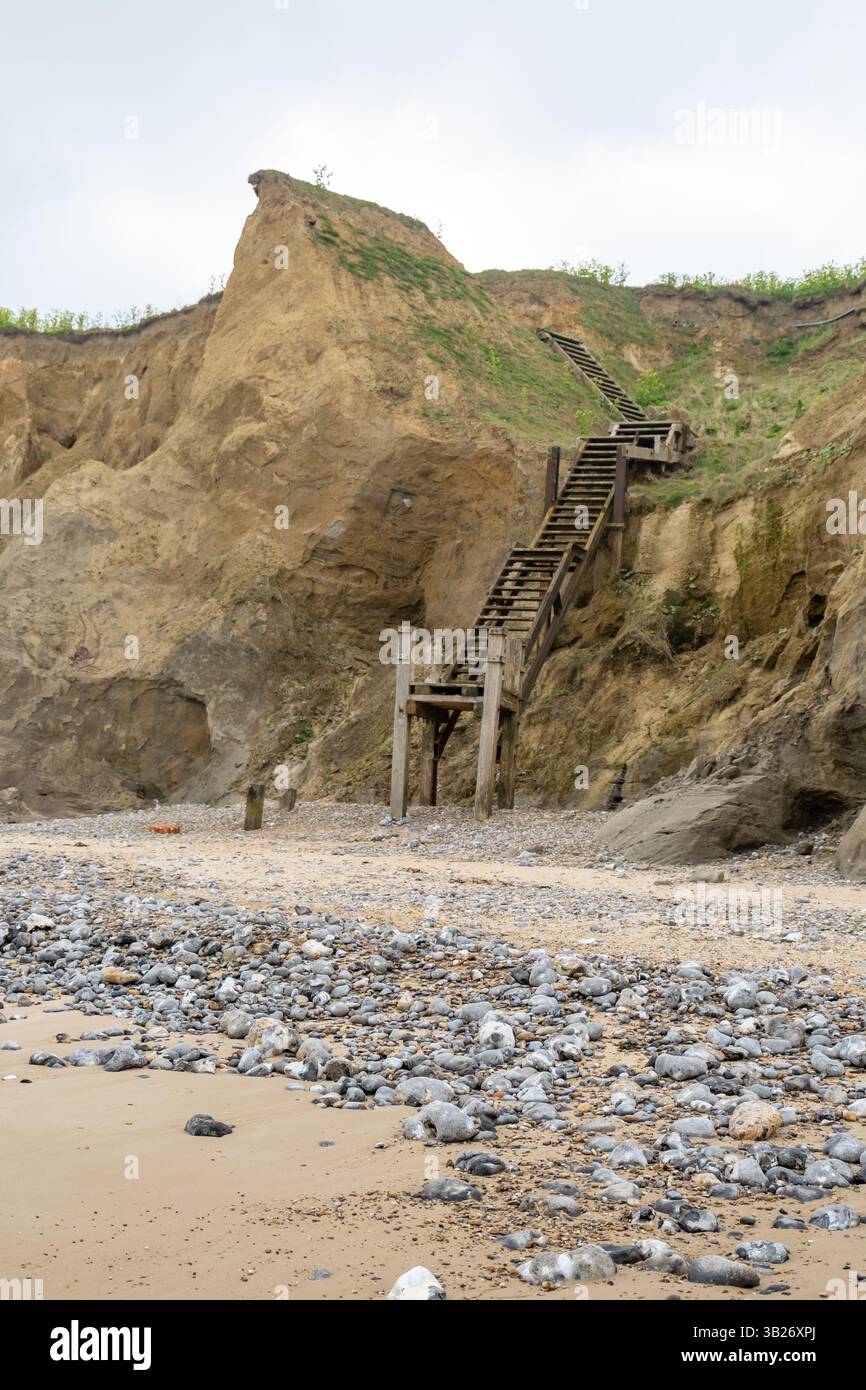 Wooden steps on the cliffside damaged by the waves and coastal erosion ...