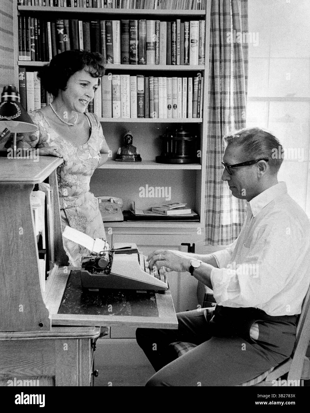 BETTY WHITE looks on as husband ALLEN LUDDEN types on a typewriter ...