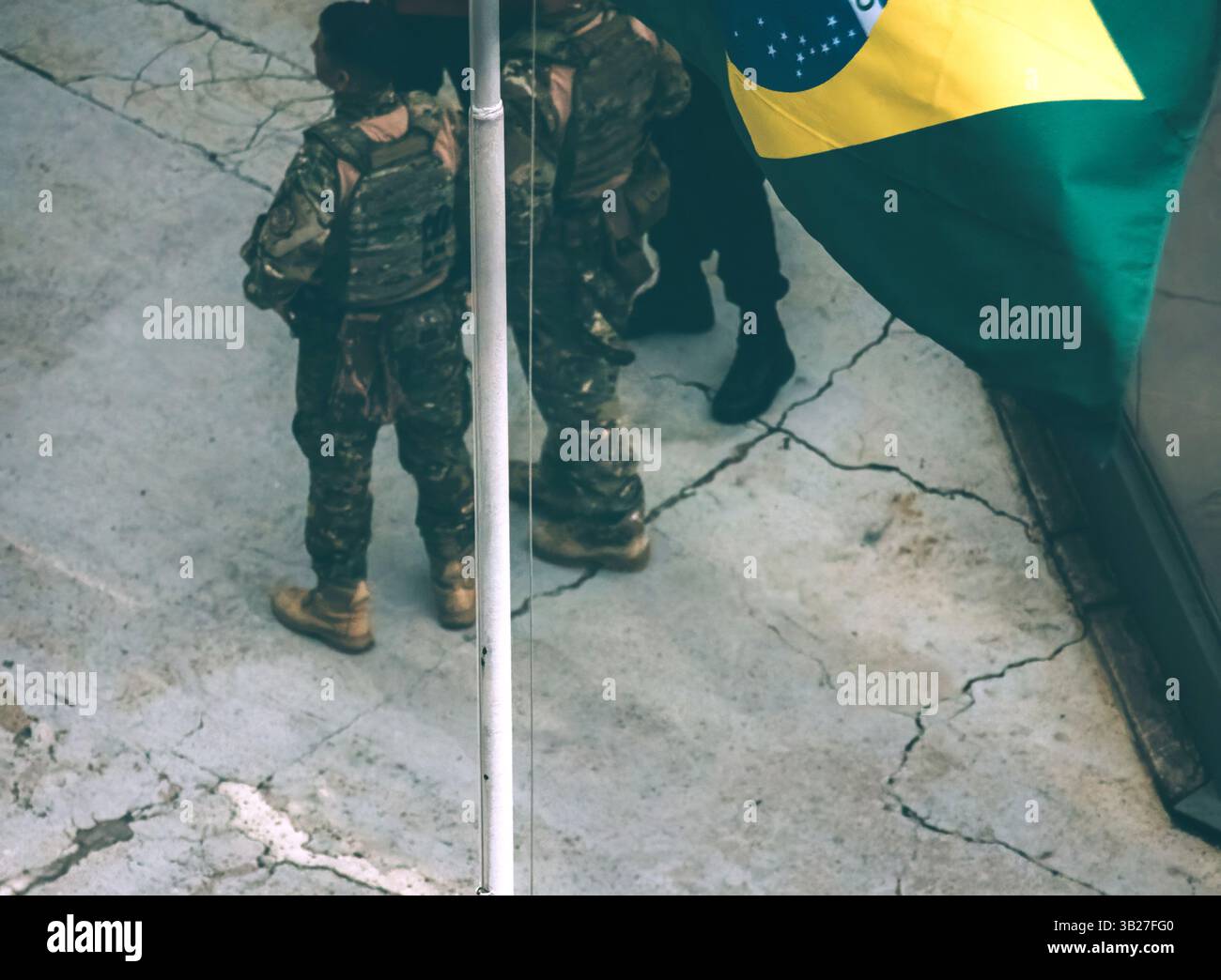 Soldiers gather in military uniform near Brazilian flag in urban ...