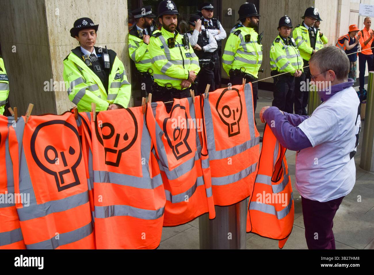London, UK. 26th April 2025. Just Stop Oil activists hang their orange ...