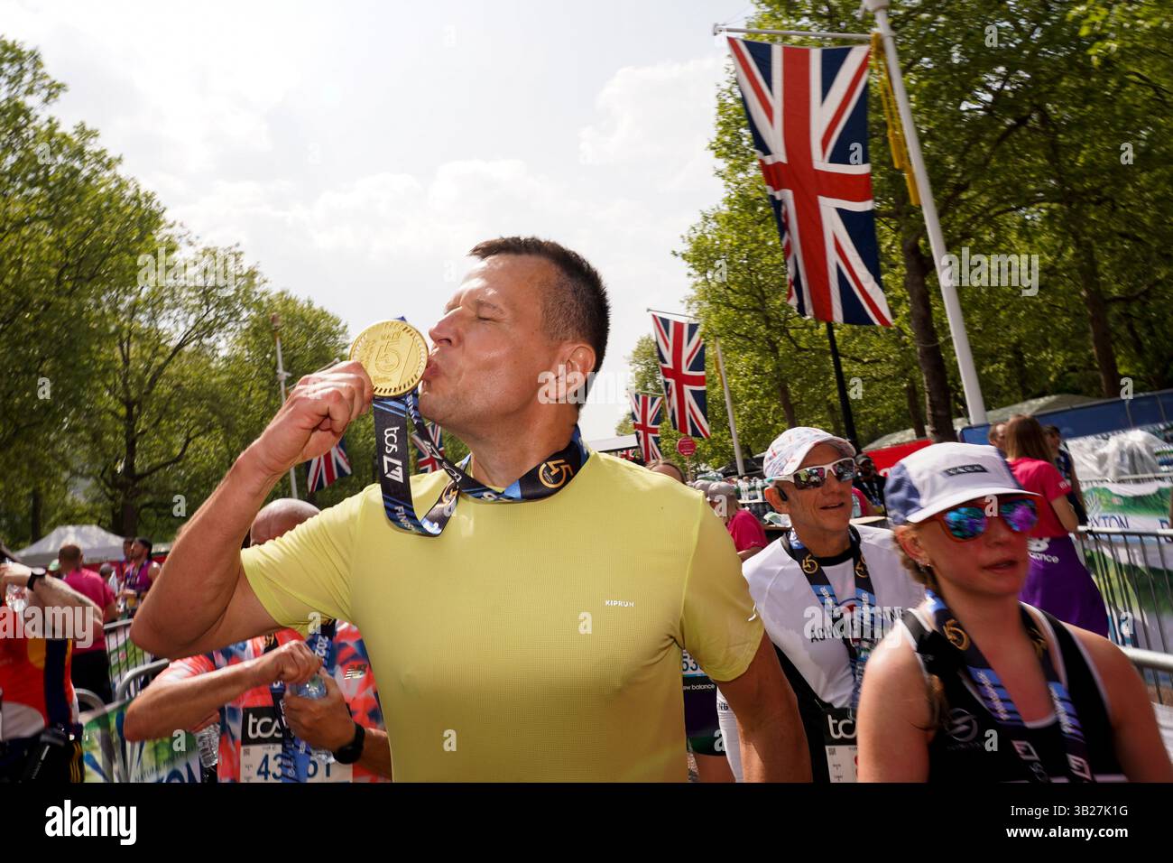 A runner kisses his finisher medal after taking part to the London ...