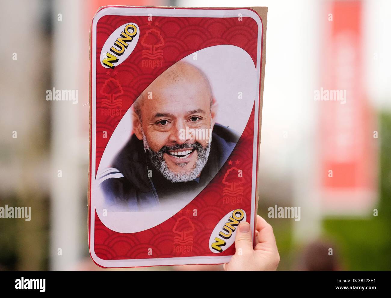 A Nottingham Forest fan holds a mock uno card that features manager Nuno Espirito Santo ahead of ...