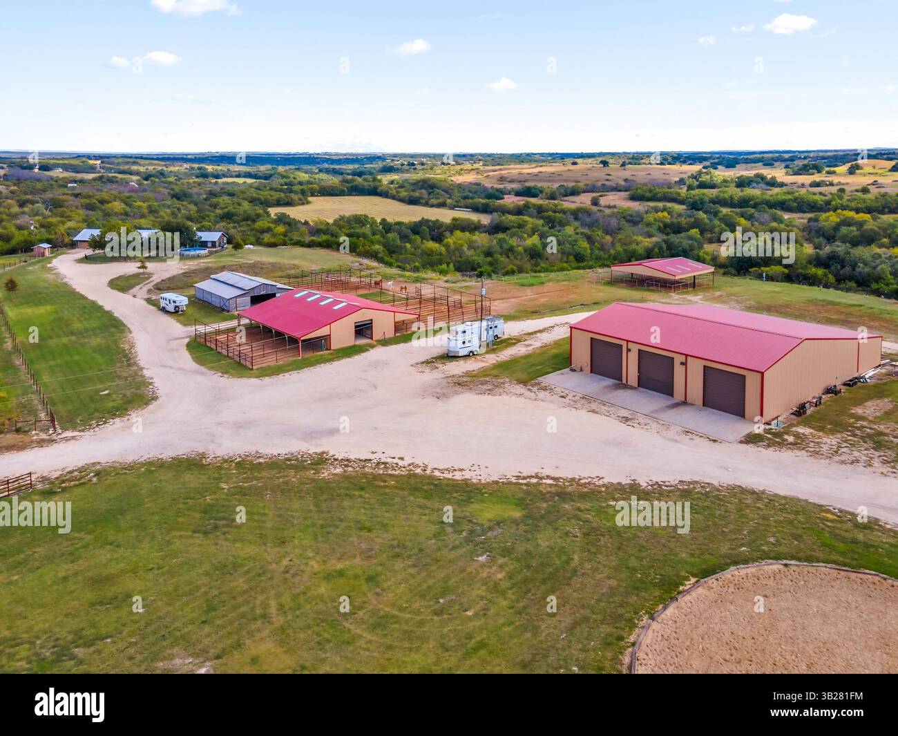Aerial view of an expansive ranch property showcasing multiple red ...