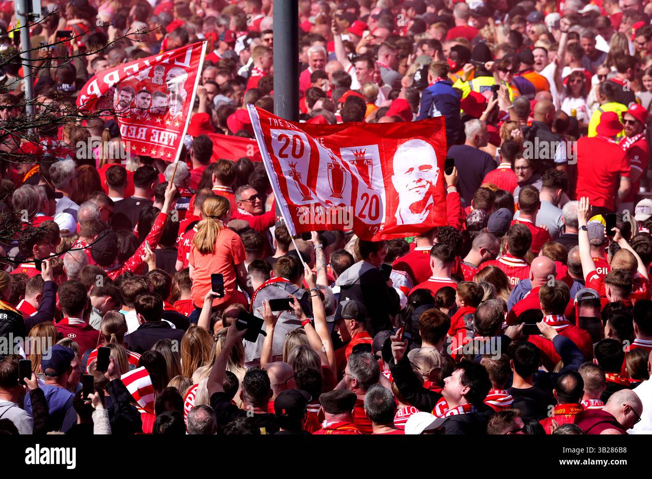Liverpool fans flag large flags of Liverpool manager Arne Slot outside ...