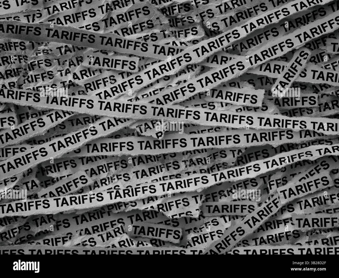 Strips of newspaper with the words Tariffs typed on them. Black and ...